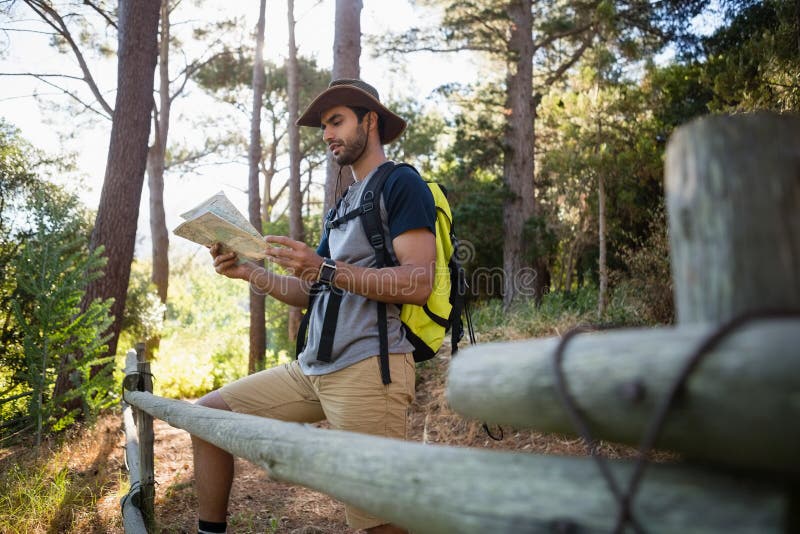Man Reading the Map Near the Wooden Fence Stock Photo - Image of ...