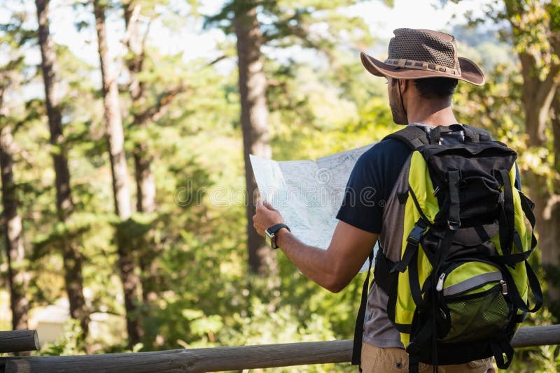 Man Reading the Map Near the Wooden Fence Stock Photo - Image of ...