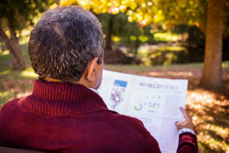 Man Reading Newspaper while Relaxing on Bench Stock Photo - Image of ...