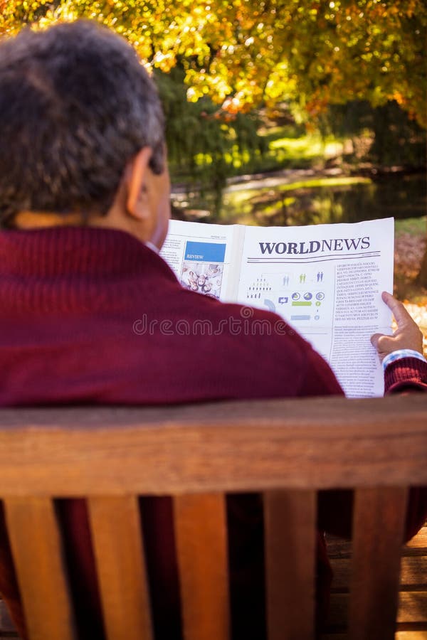 Man Reading Newspaper while Resting on Bench Stock Photo - Image of ...