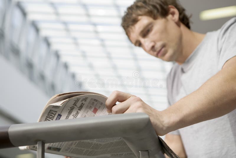 Man Reading Newspaper in Shopping Center Stock Image - Image of people ...