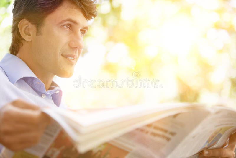 Man Reading Newspaper in Sunny Park Stock Image - Image of relax ...
