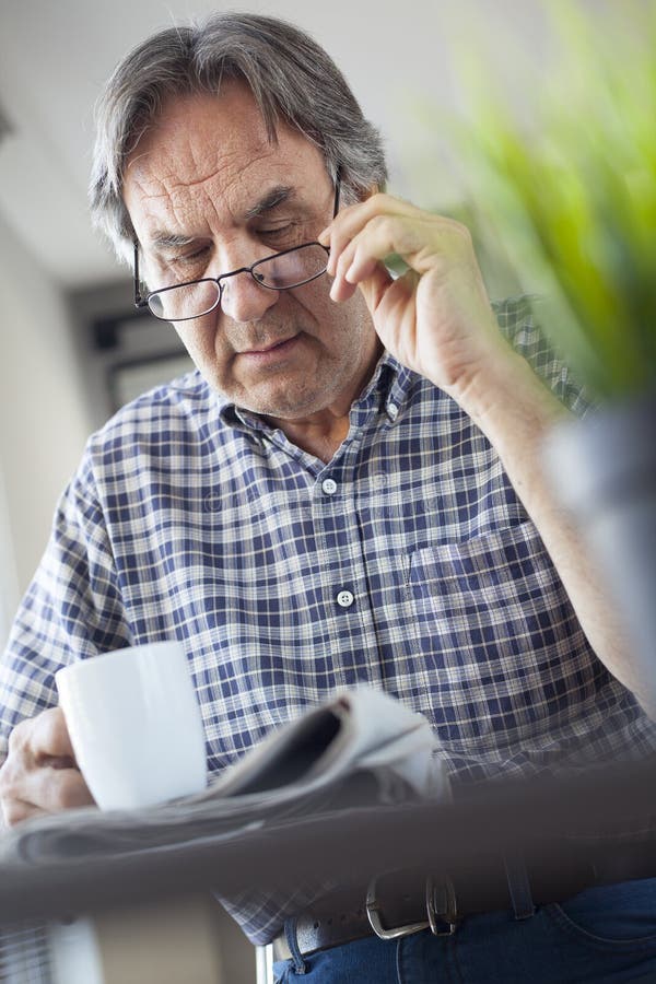 Man Reading Newspaper on Table Stock Photo - Image of paper, printed ...