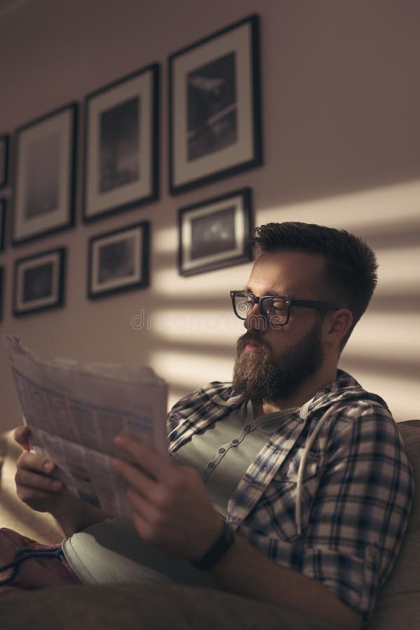 Man reading the newspapers stock photo. Image of person - 112070040