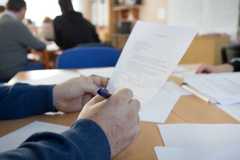 Man Reading Paper at Workshop Stock Photo - Image of school, male: 82470482