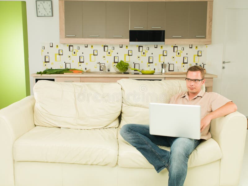 Man Reading Something on Laptop Stock Photo - Image of interior, lying ...