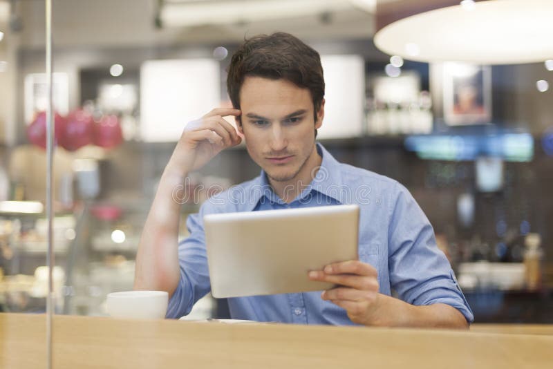 Man Reading Something on Tablet Stock Photo - Image of coffee ...