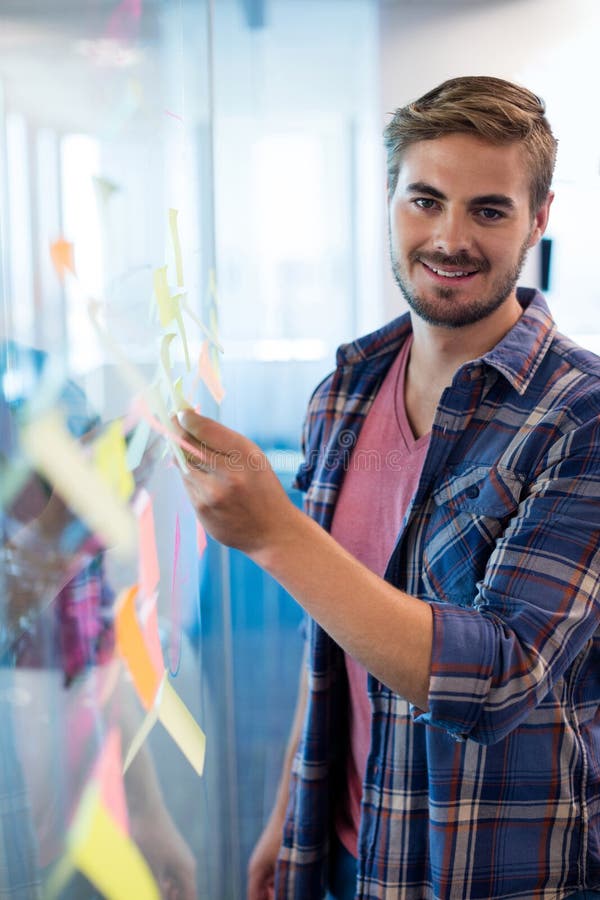 Man Reading Sticky Notes on the Glass Wall in Office Stock Photo ...