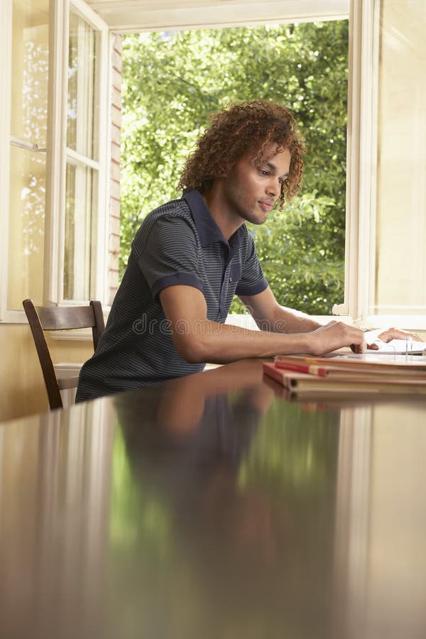 Man Reading at Table by Window Stock Photo - Image of looking, african ...