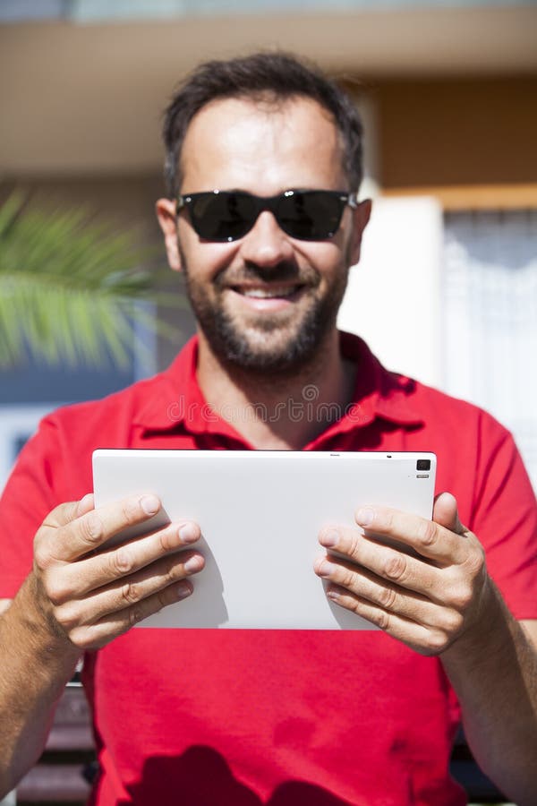 Man Reading Tablet. Focus on Tablet. Stock Image - Image of outdoor ...
