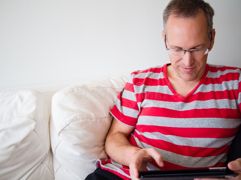 Man reading on a tablet stock image. Image of person - 31334393