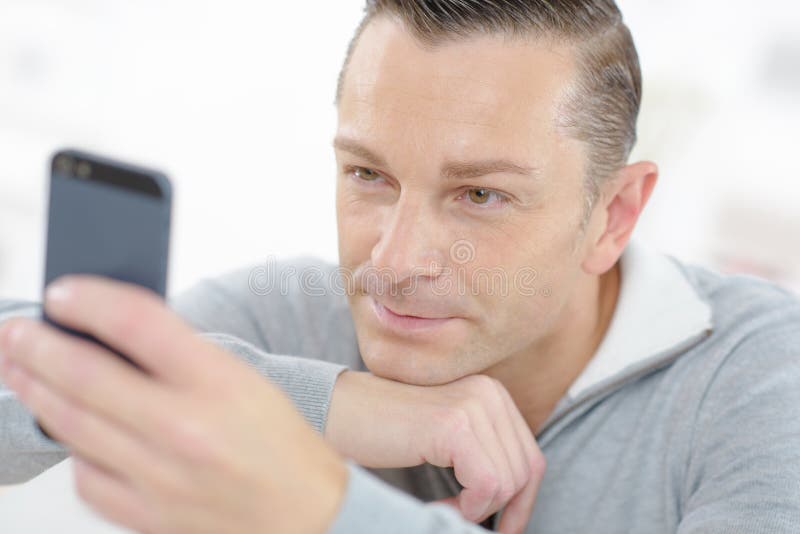 Man reading text message stock image. Image of holding - 84259805