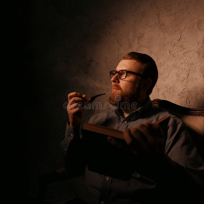 Man Reads a Book in a Dark Room and Smoking Pipe. 4K UHD Stock Image ...