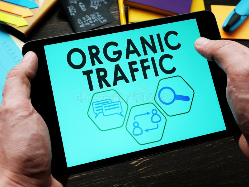 A Man Reads Information about Organic Traffic on a Tablet. Stock Photo ...