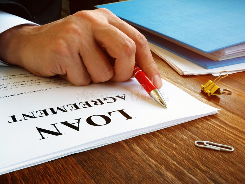Man Reads Loan Agreement for Signing Stock Photo - Image of document ...