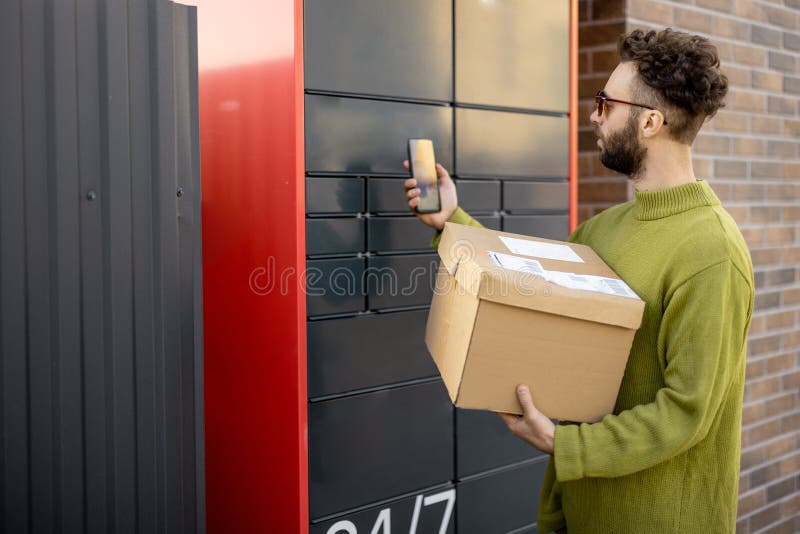 Man Receiving Parcel from Automatic Post Box Stock Photo - Image of ...