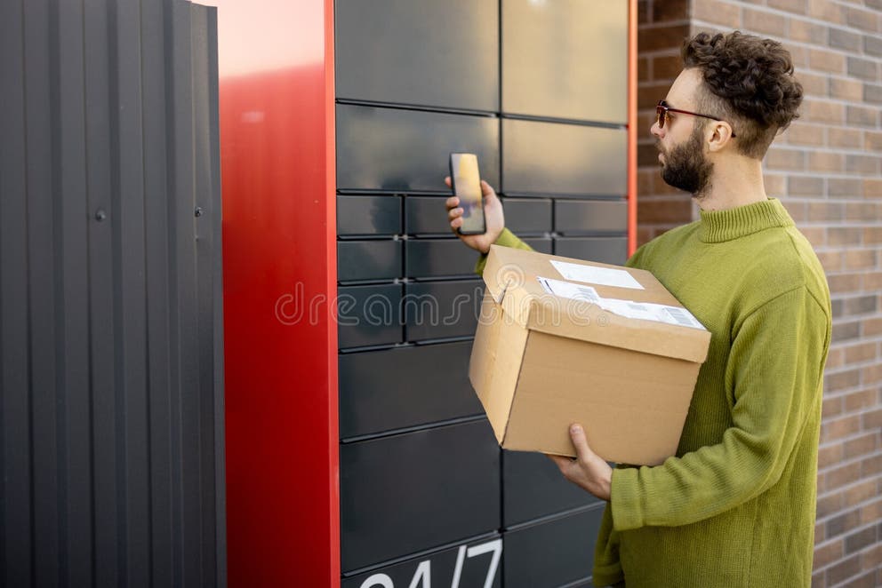 Man Receiving Parcel from Automatic Post Box Stock Photo - Image of ...