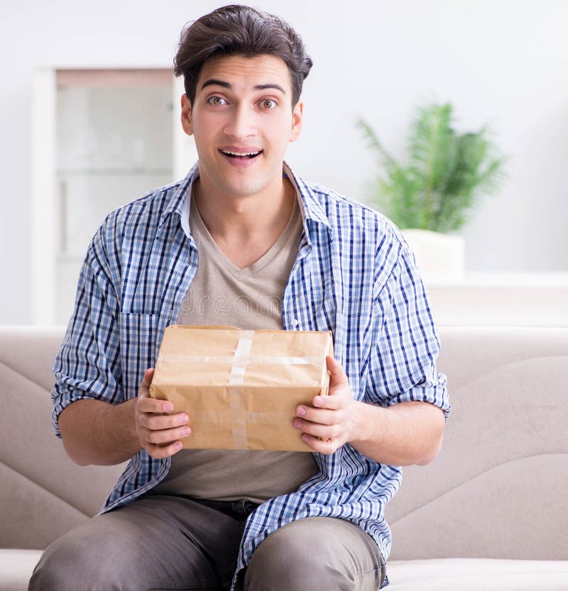Man Receiving Parcel at Home Stock Photo - Image of packet, post: 210490246