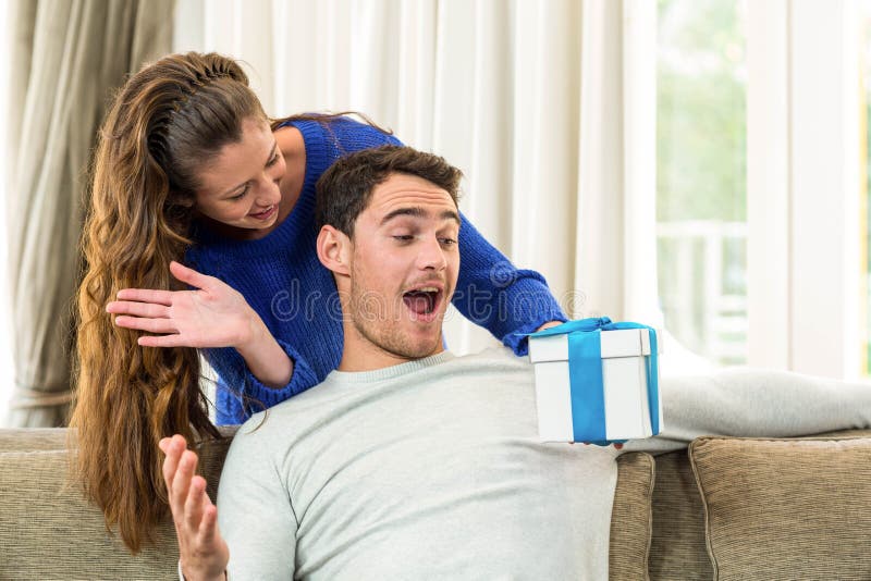 Man Receiving a Surprise Gift Stock Photo - Image of brunette ...