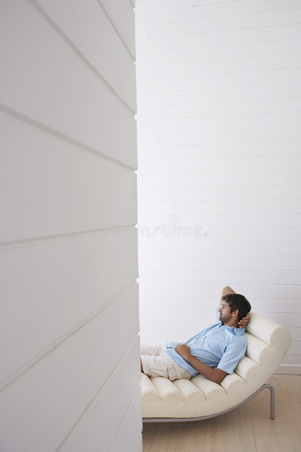 Man Reclining on Lounge Chair at Home Stock Photo - Image of caucasian ...