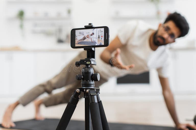 Man Recording Fitness Tutorial Video with Smartphone on Tripod at Home ...