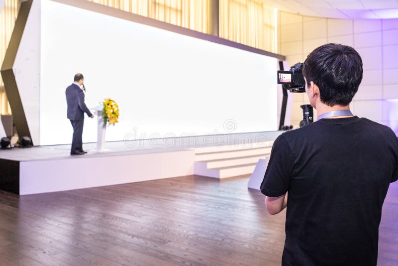 Man Recording a Speaker with White Wall Screen Editorial Image - Image ...