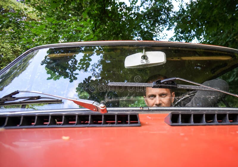 Man in a red car stock image. Image of metal, oldtimer - 97015961