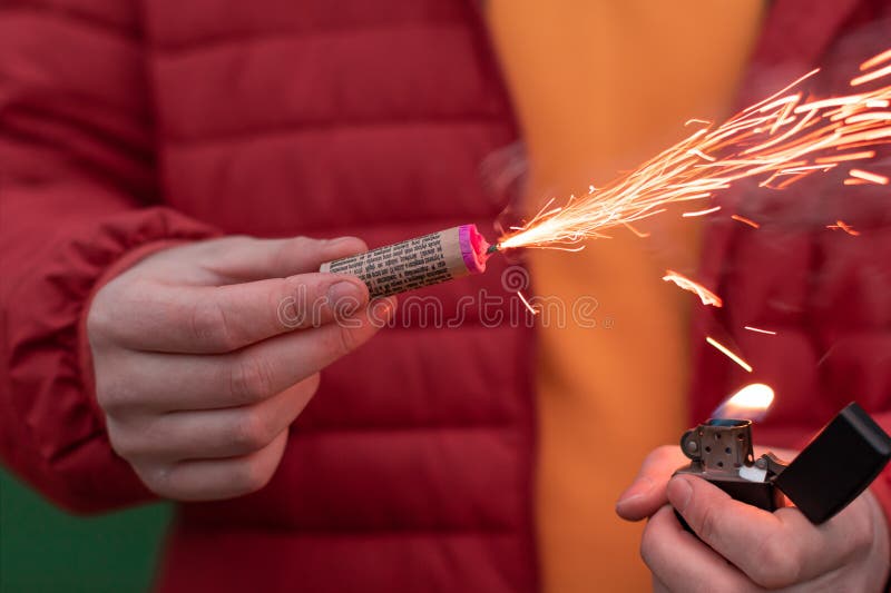 Man in Red Jacket Lighting Up Firecracker in His Hand Stock Image ...