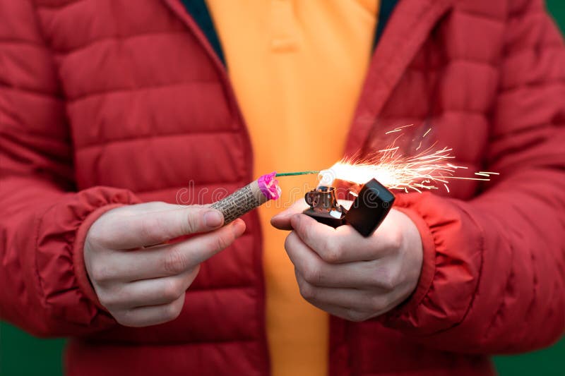 Man in Red Jacket Lighting Up Firecracker in His Hand Stock Photo ...