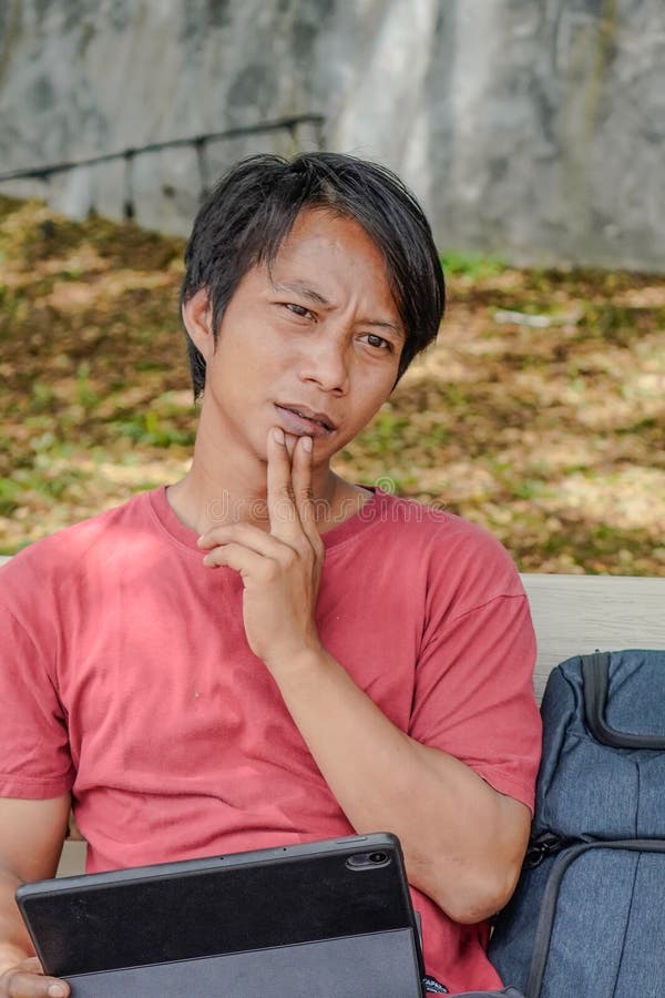 Javanese Man Thinking on a Park Bench. Stock Image - Image of clothing ...
