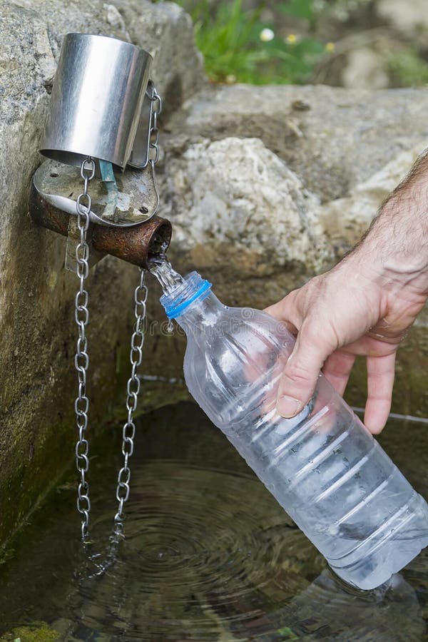 A Man Refilling Spring Water Stock Photo - Image of clean, hiking ...