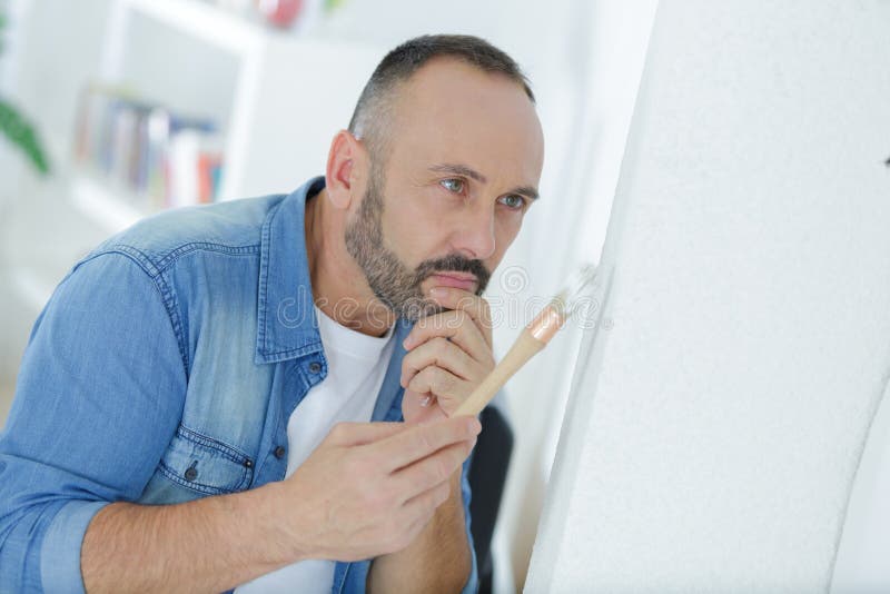 Man Reflects on Painting Decision Stock Image - Image of concerned ...