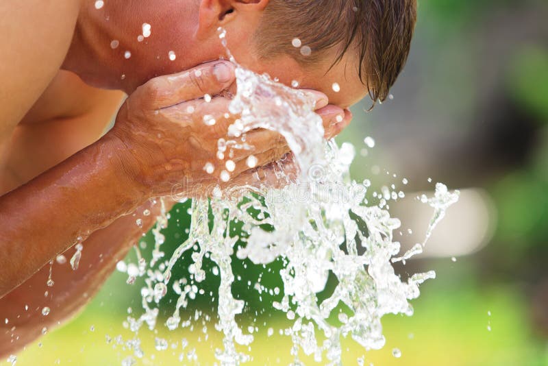 A Man Refreshes Himself with a Splash of Water Stock Photo - Image of ...