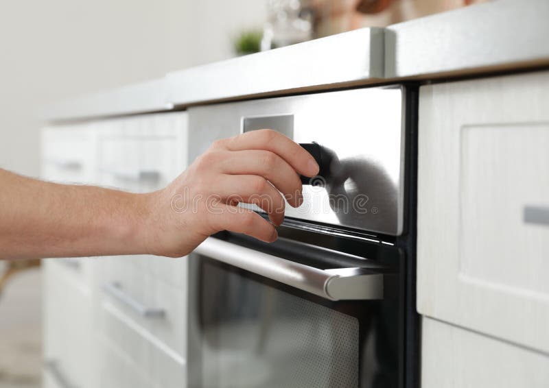 Man Regulating Cooking Mode on Oven Panel in Kitchen, Stock Photo ...