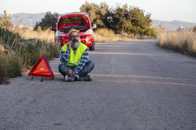 Man with Relaxed Attitude Stranded on the Road Next To the Broken Down ...