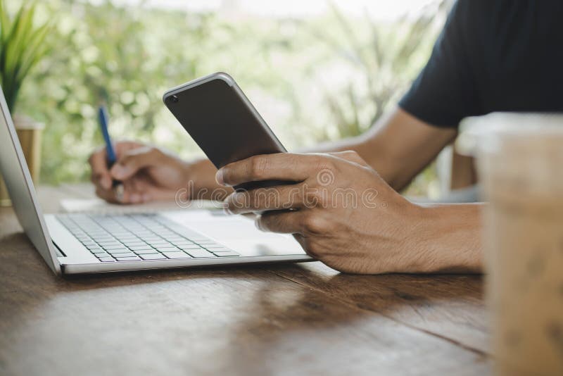 Man Relaxed Writing and Working with Digital Mobile Smart Phone, Laptop ...