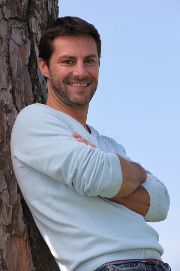 Man Relaxing Against a Tree Stock Image - Image of mustache, outdoors ...