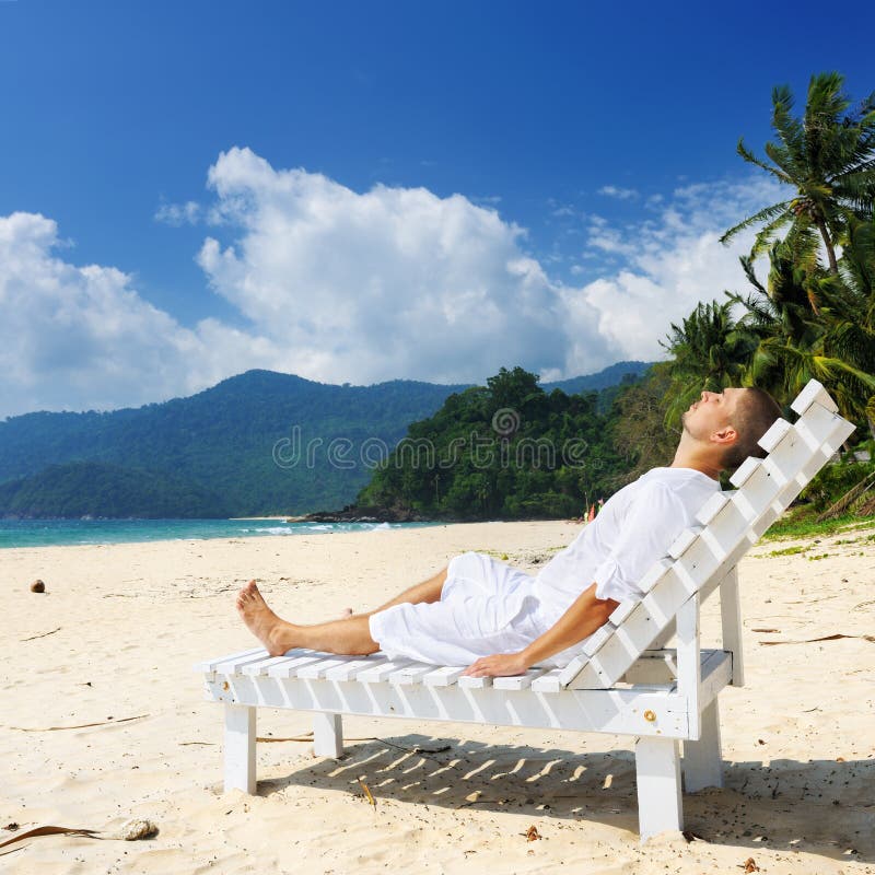 Man relaxing on a beach stock photo. Image of leisure - 29319248
