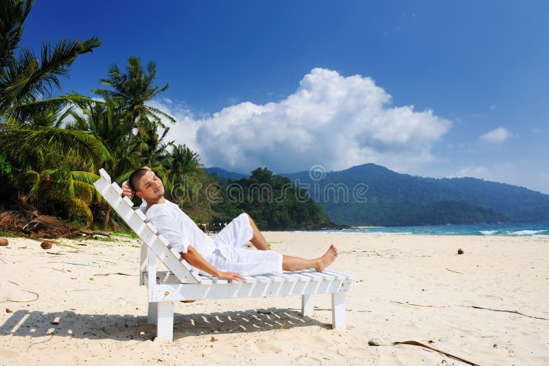 Man relaxing on a beach stock photo. Image of summer - 29027976