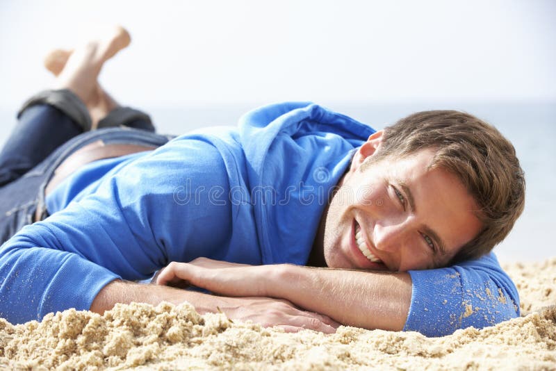 Man Relaxing on Beach stock photo. Image of horizontal - 55897298