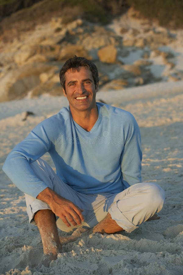 Man Relaxing on Beach in Evening Light Stock Image - Image of vertical ...