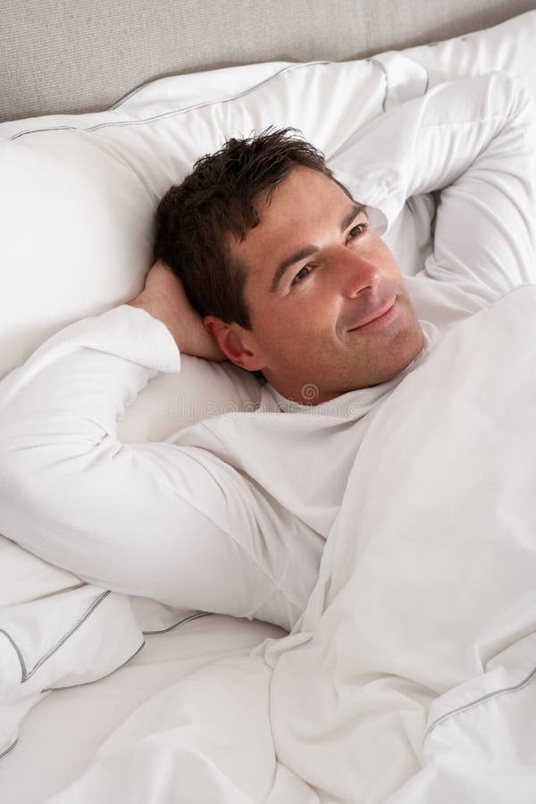 Man Relaxing in Bed stock image. Image of dreaming, peaceful - 19062933