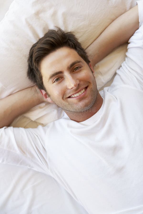 Man Relaxing in Bed stock image. Image of relaxed, bedclothes - 55896775
