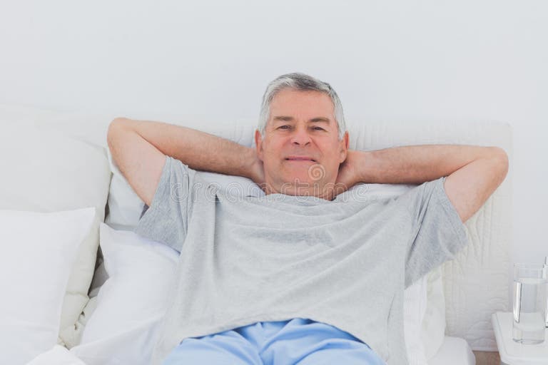 Man relaxing in bed stock photo. Image of pajama, male - 32231526