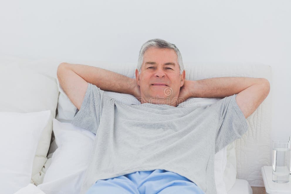 Man relaxing in bed stock photo. Image of pajama, male - 32231526