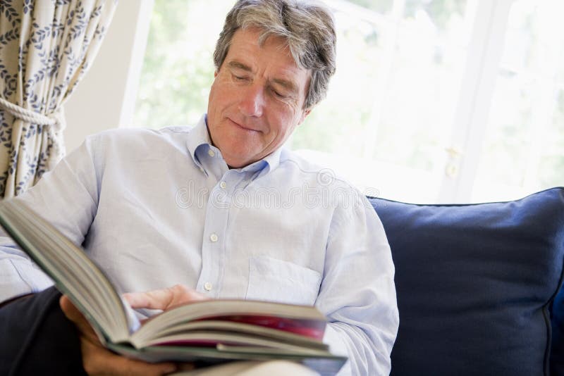 Man Relaxing with Book in Living Room Stock Photo - Image of people ...
