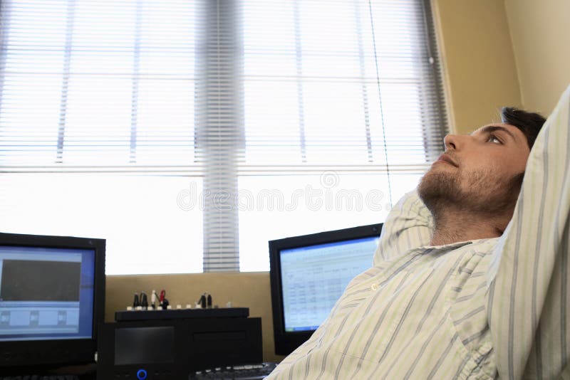 Man Relaxing by Computers stock photo. Image of leaning - 33889674