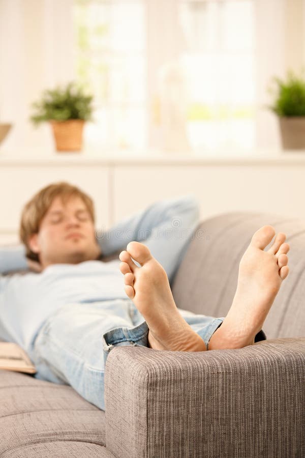 Man relaxing on couch stock image. Image of closed, indoor - 19674271
