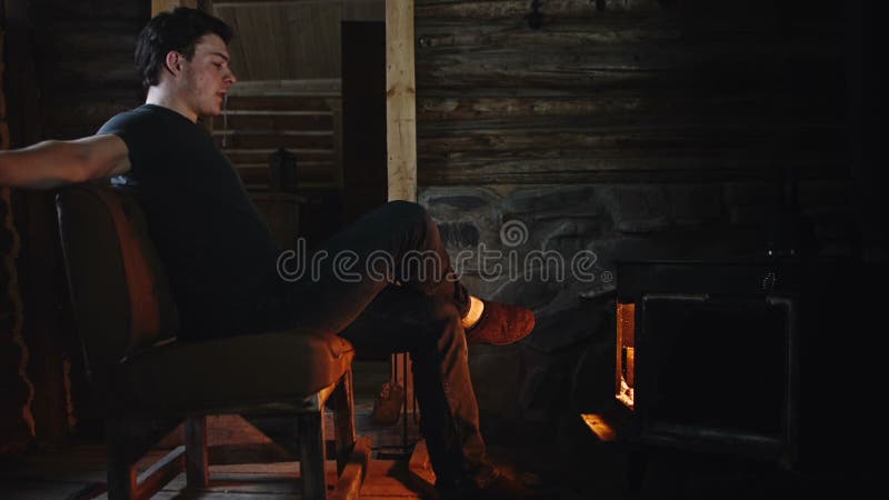 Man Relaxing in Front of an Opened Slow Burning Stove Stock Footage ...