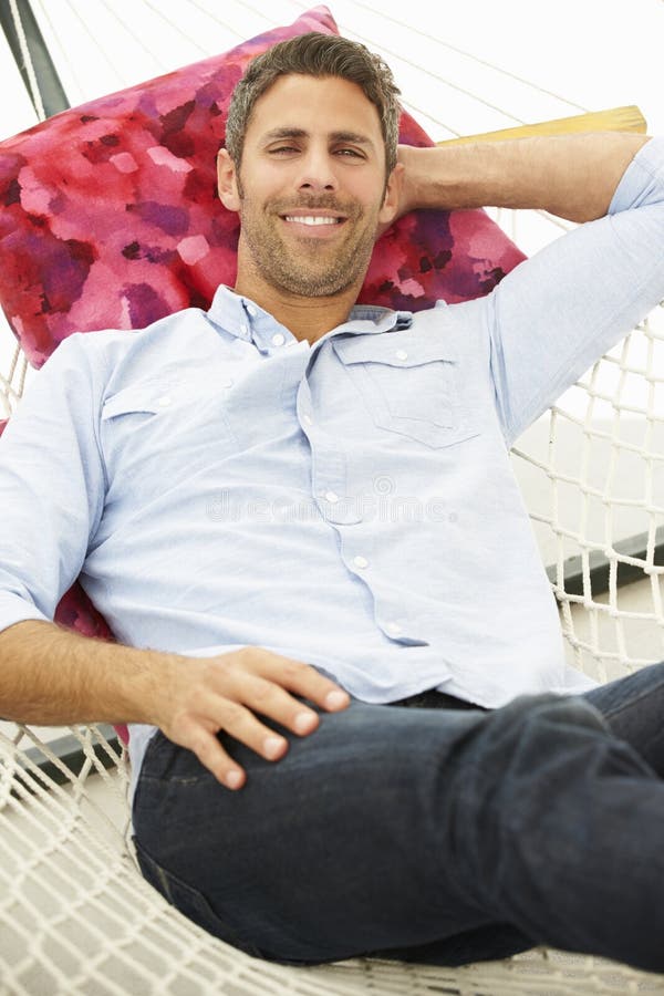 Man Relaxing in Garden Hammock Stock Image - Image of resting, lying ...
